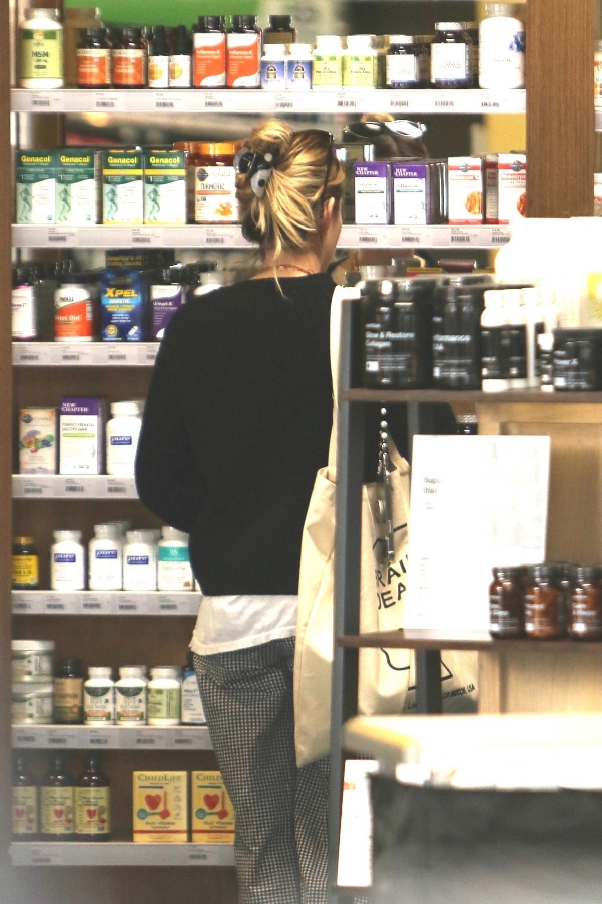 EMMA ROBERTS Shopping for Health Supplements at Earth Bar in West ...