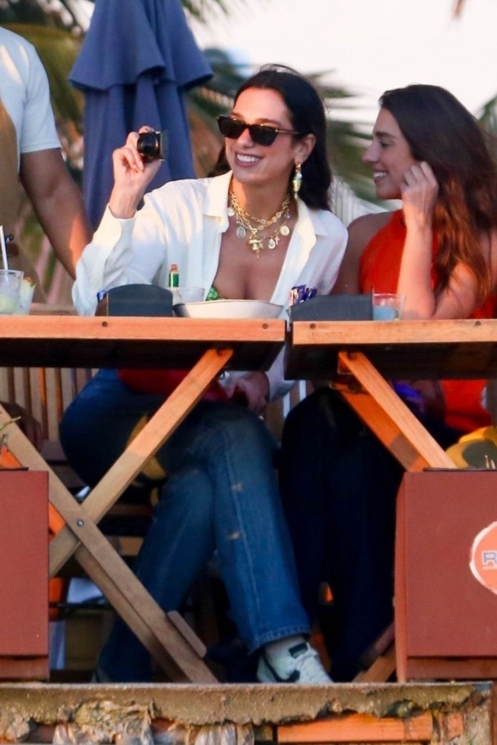 DUA LIPA Enjoys a Drink with Family on Ipanema Beach in Rio De Janeiro ...